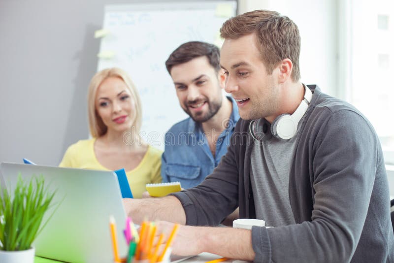 Cute Friendly Team Using Notebook in Office Stock Image - Image of ...