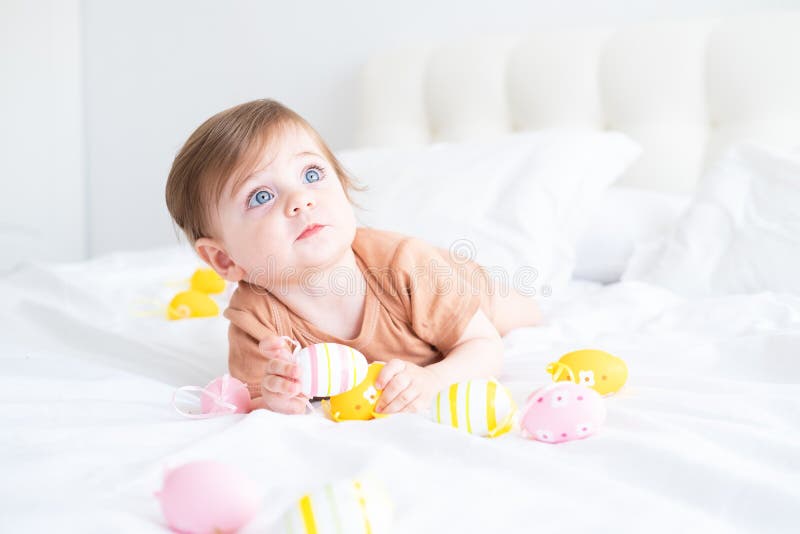 Cute Funny Baby with Colorful Easter Eggs on White Bed at Home Stock ...