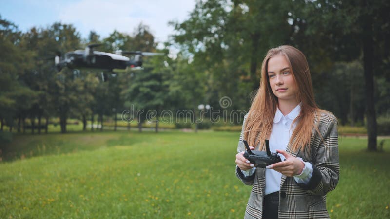 A Cute Girl Controls a Drone in the Park. Stock Video - Video of radio ...