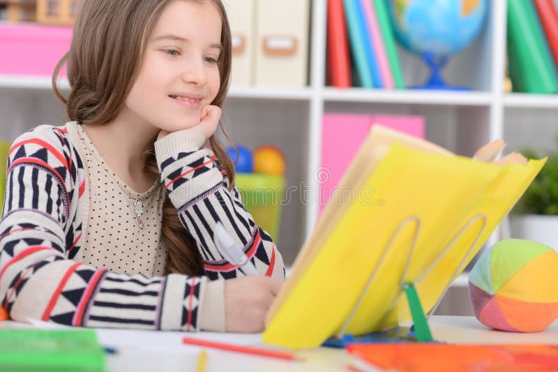 Cute girl does lessons stock image. Image of book, preschool - 88429851