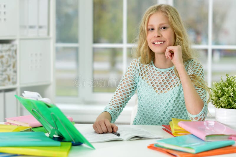 Cute girl does lessons stock image. Image of people, woman - 91541829