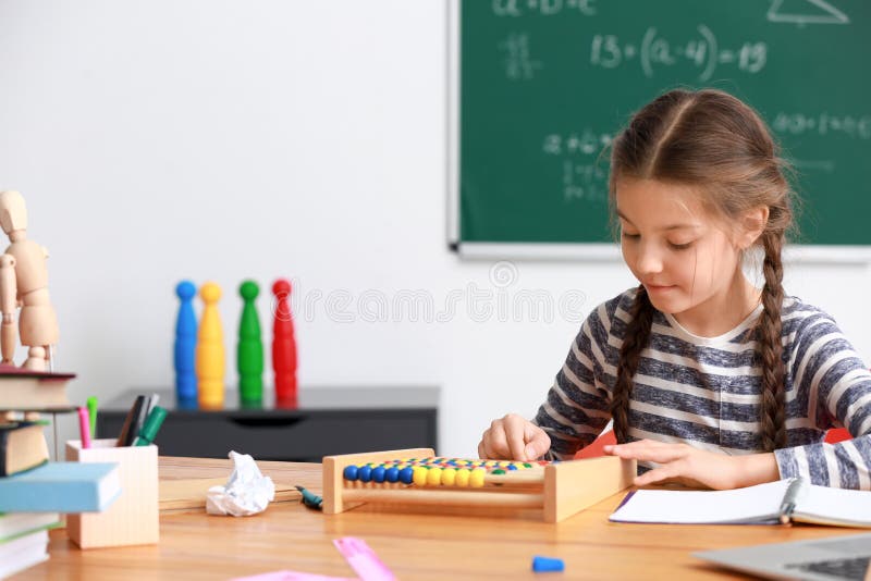 Cute Girl Doing Homework in Classroom Stock Photo - Image of elementary ...