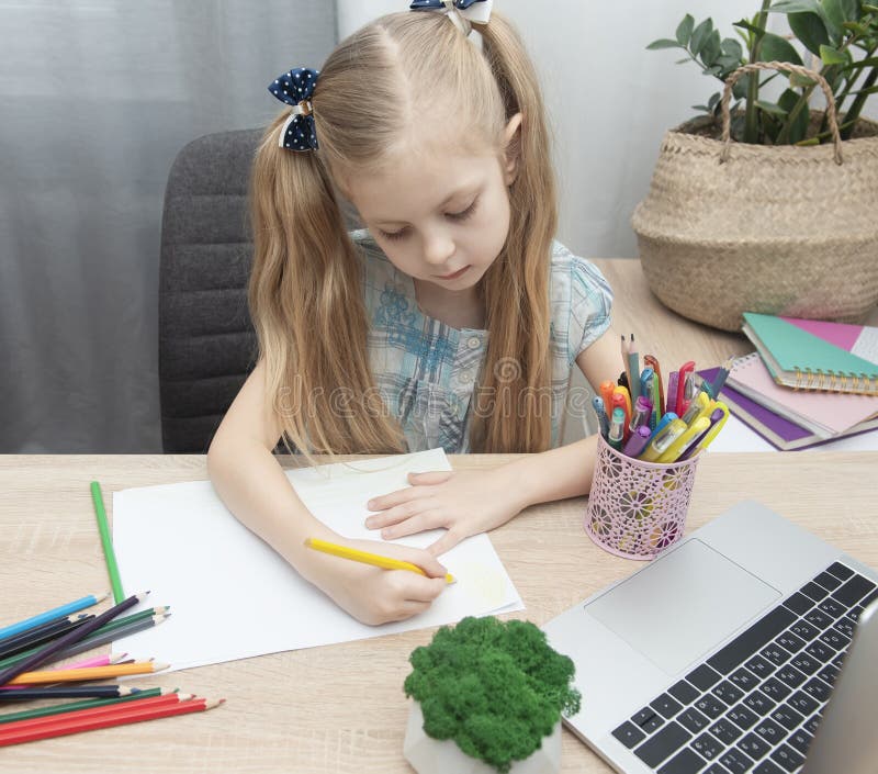 Cute girl doing homework stock photo. Image of childhood - 211340100