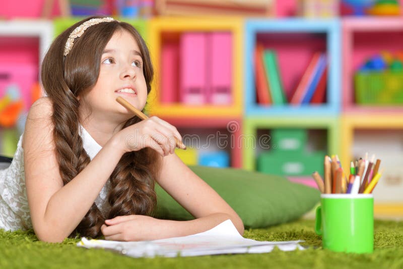 Cute girl doing homework stock photo. Image of pencils - 95861944