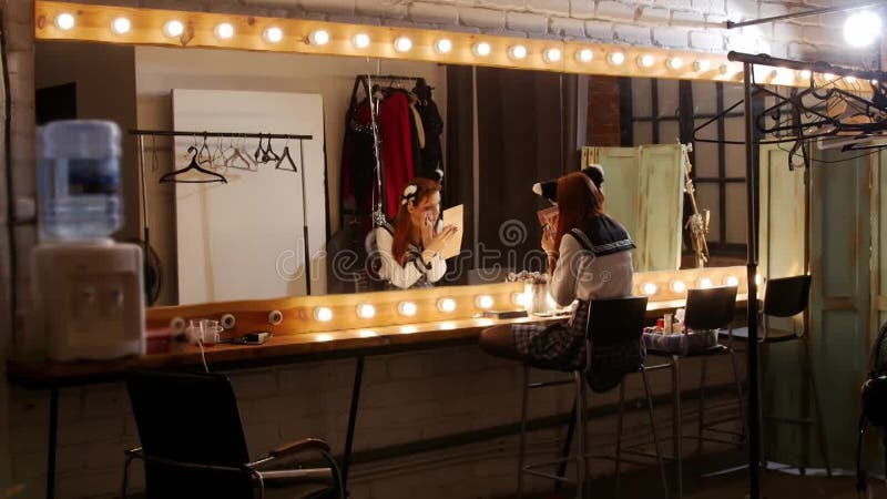 A Cute Girl Doing Makeup Sitting on the Backstage Stock Video - Video ...