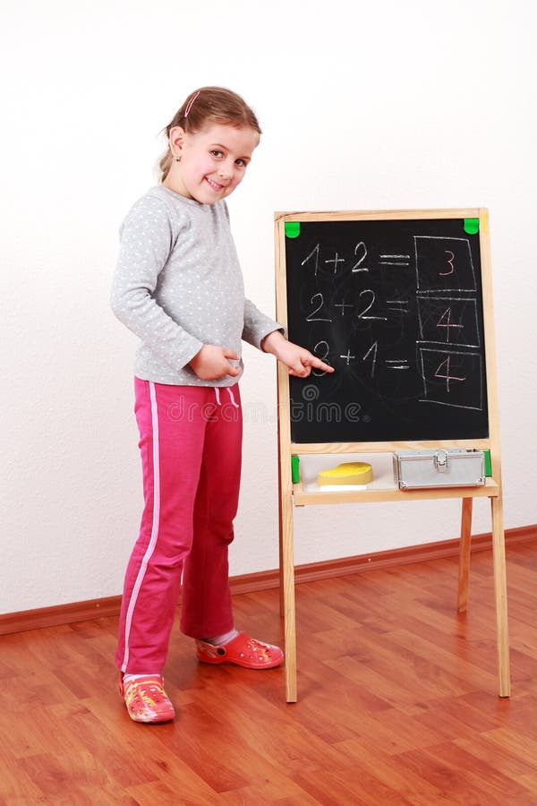 Cute girl doing math stock photo. Image of board, home - 22706760