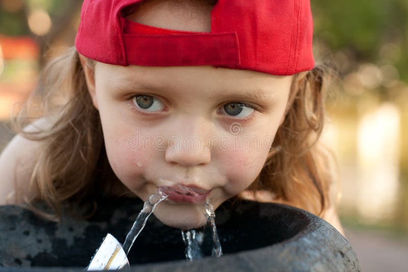 Cute Girl Drinking from a Water Fountain Stock Image - Image of child ...