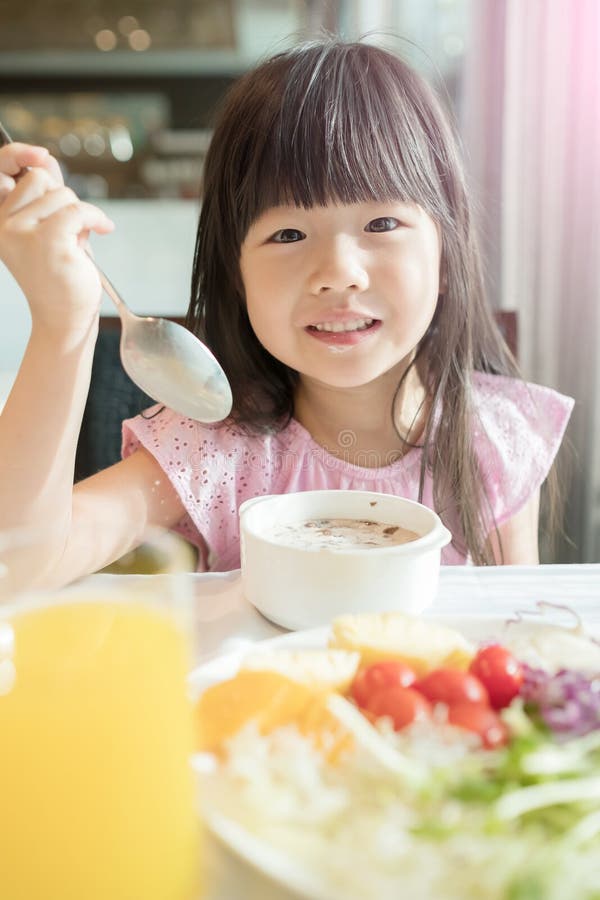 Cute girl eat breakfast stock photo. Image of girl, child - 91329960