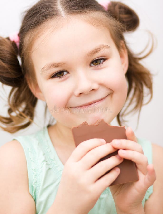 Cute Girl is Eating Chocolate Candy Stock Photo - Image of funny ...