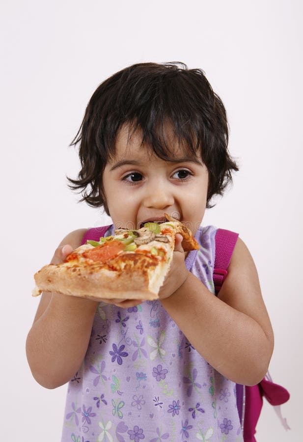 Cute girl eating pizza stock photo. Image of looking - 12749040