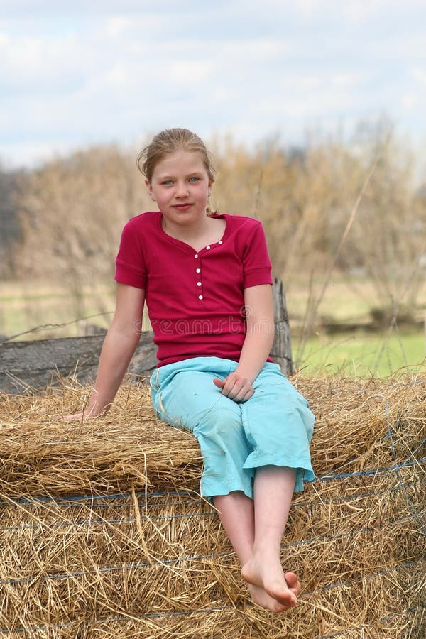 Cute girl on hay bale stock photo. Image of outside, girl - 2345882