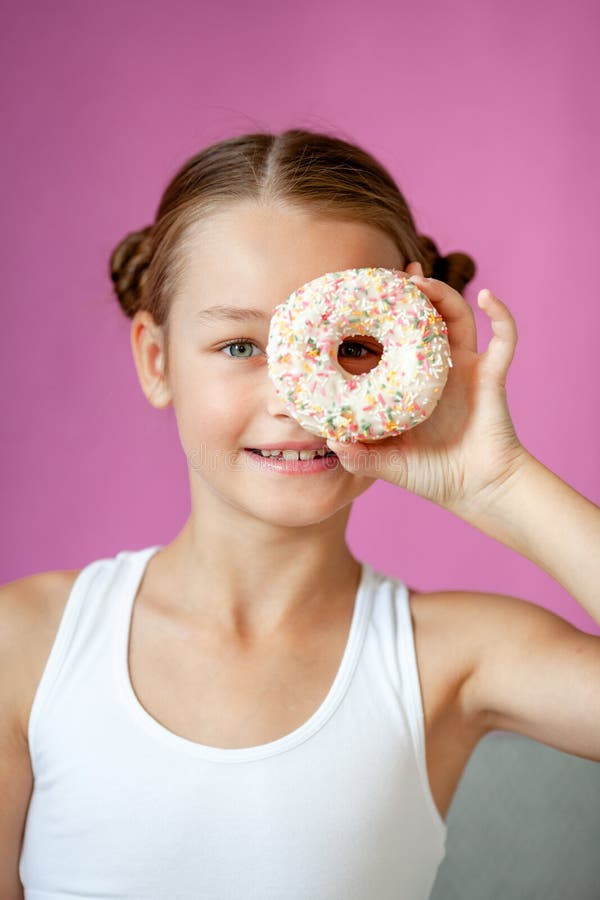 Cute Girl Holding an Appetizing Glazed Donut in Her Hands Stock Photo ...