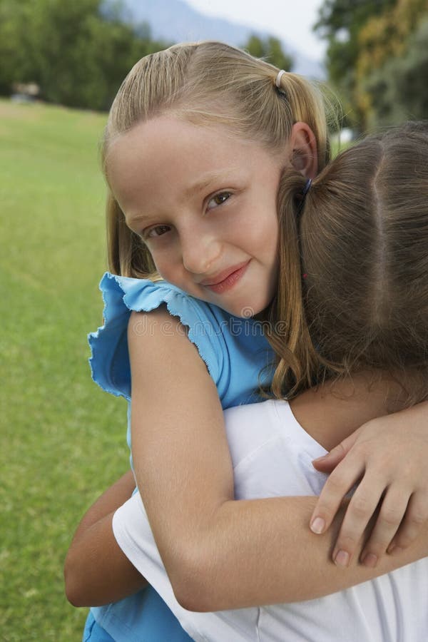 Cute Girl Hugging Her Friend Stock Photo - Image of person, happy: 29658268