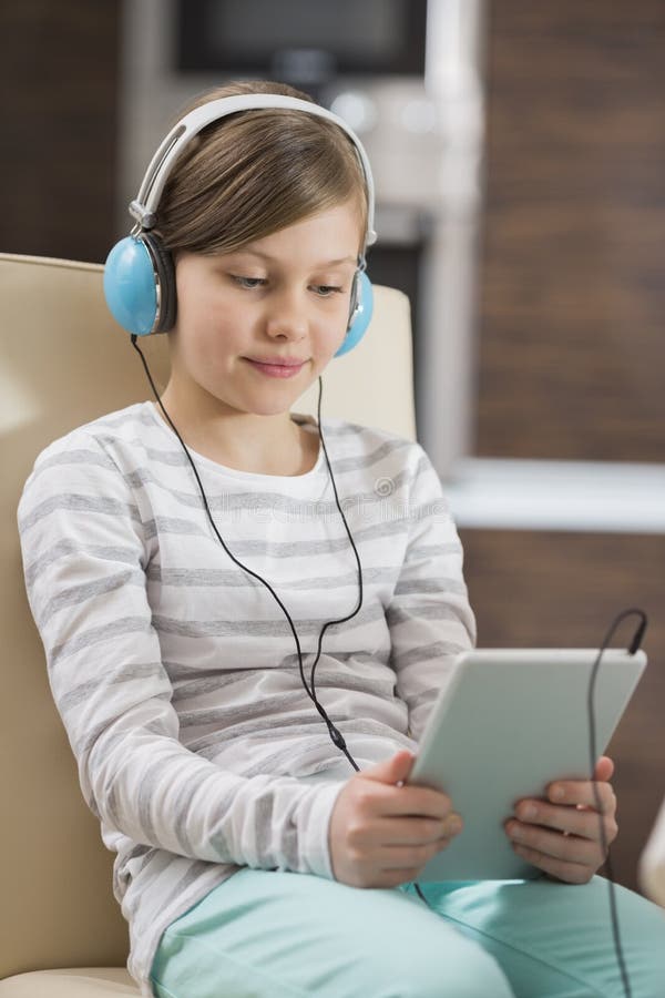 Cute Girl Listening Music while Using Digital Tablet at Home Stock ...