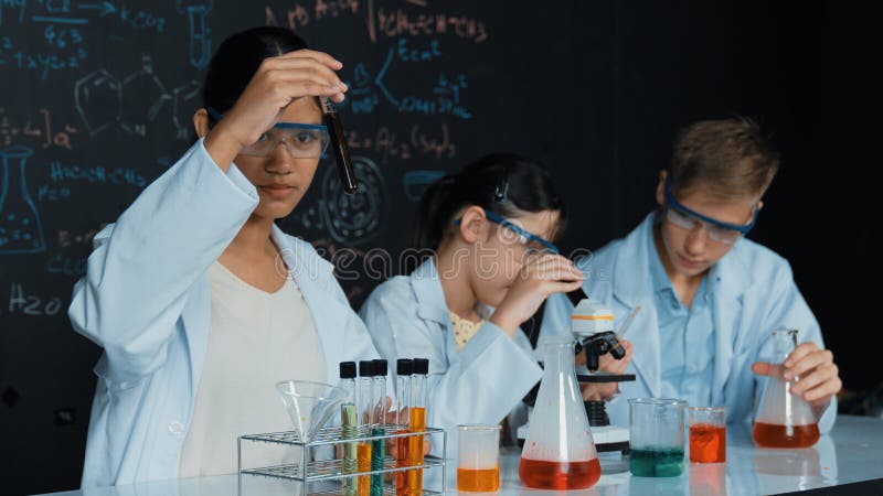 Cute Girl Looking Under Microscope while Student Doing Experiment ...