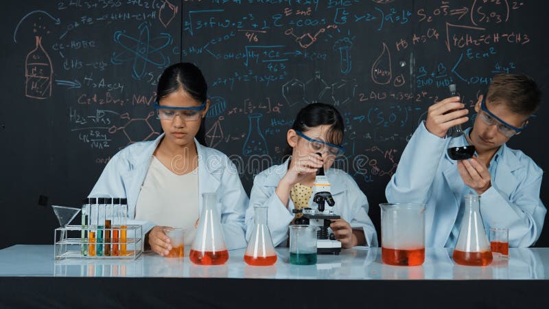Cute Girl Looking Under Microscope while Student Doing Experiment ...