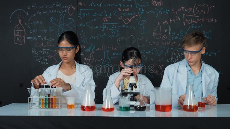Cute Girl Looking Under Microscope while Student Doing Experiment ...