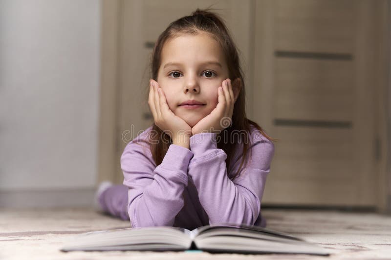 Cute Girl Lying on the Floor and Reading a Book Stock Image - Image of ...