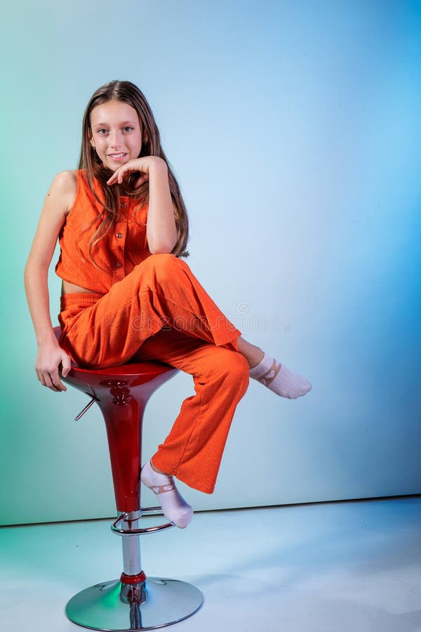 Cute Girl Model Posing Sitting on a Red Chair Stock Image - Image of ...