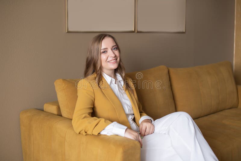 Cute Girl in the Office Sitting on the Couch Stock Photo - Image of ...