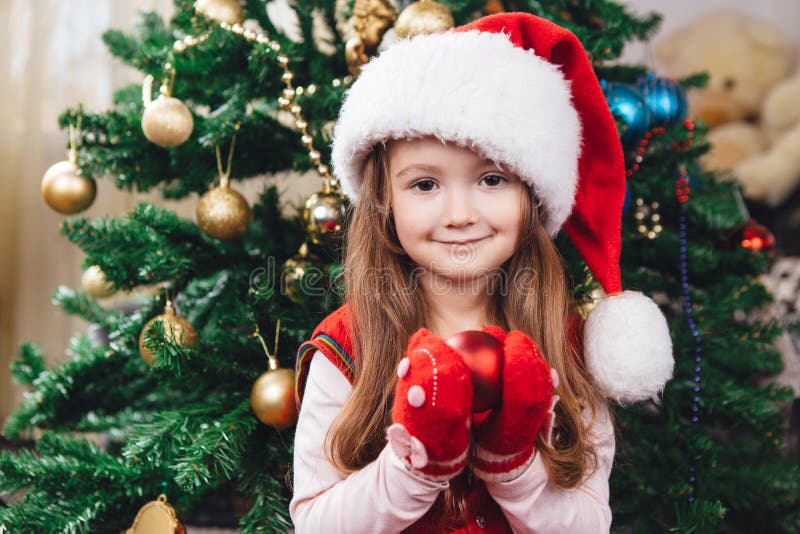 Cute Girl in Red Hat Hold a Tree Decoration Stock Image - Image of ...