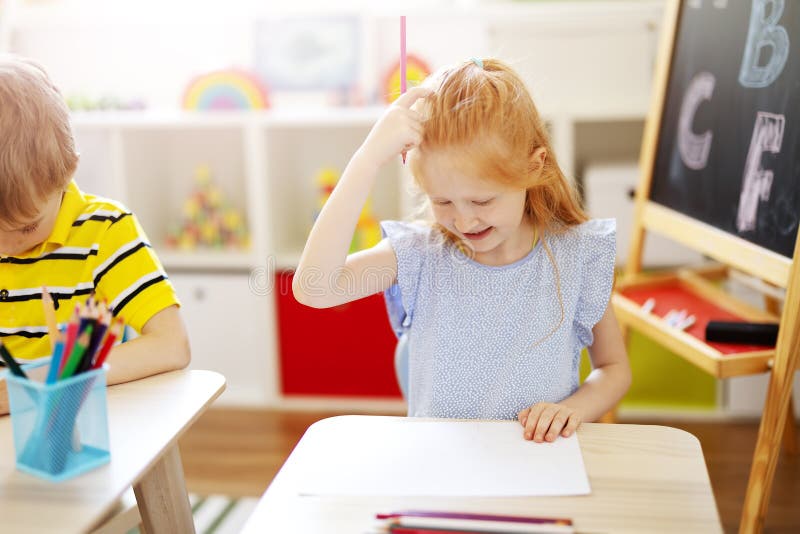 Cute Girl Sitting in the Classroom and Thinking Over a Task Stock Photo ...
