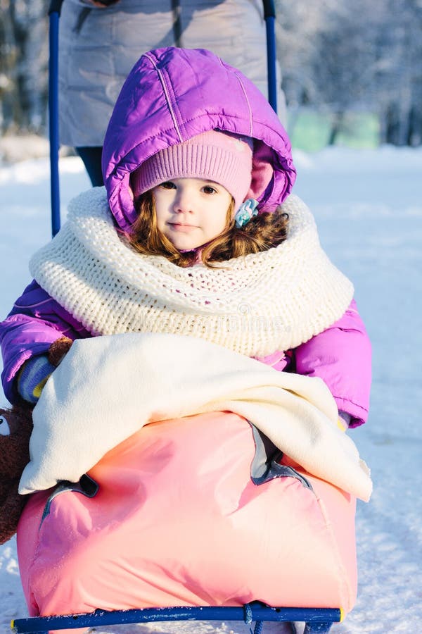 Cute Girl Sitting in the Sled in Winter Park. Stock Image - Image of ...