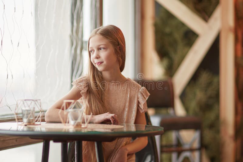 Cute Girl Sitting at a Table in a Cafe Stock Photo - Image of cute ...