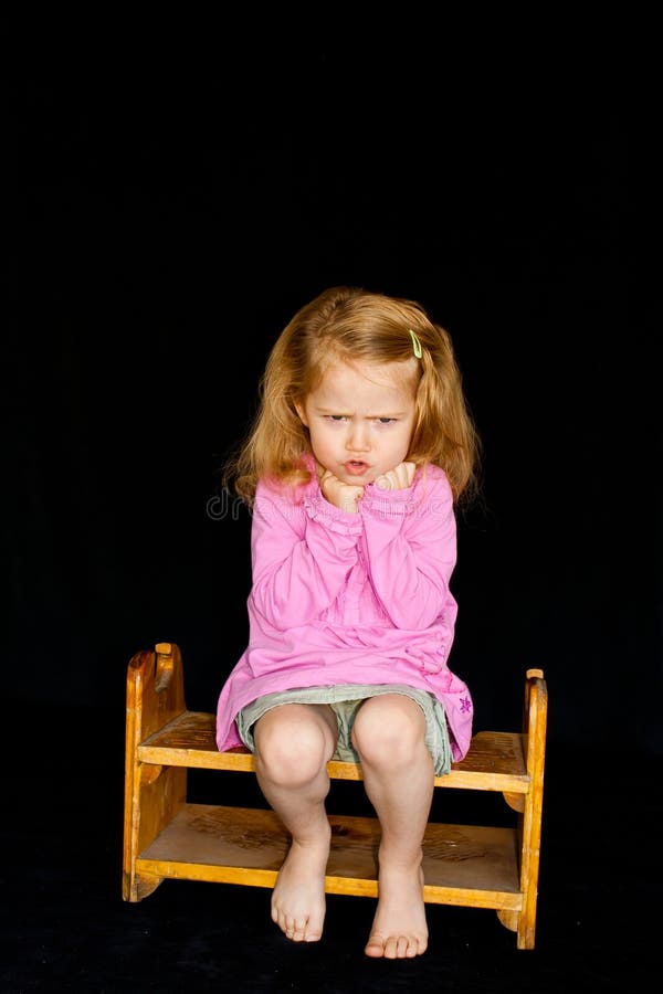 Cute Girl On A Stool Pouting Picture. Image: 17897943