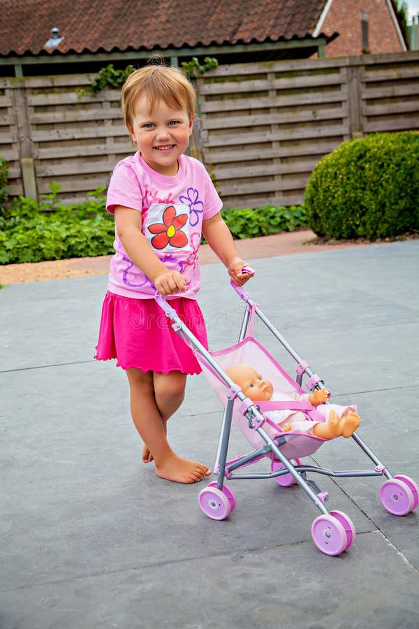 Cute Girl with Toy Stroller Stock Image - Image of grass, baby: 38888923