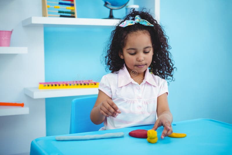 Cute Girl Using Modeling Clay Stock Photo - Image of mixedrace ...