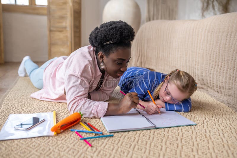 A Cute Girl Writing Something and Looking Involved Stock Photo - Image ...