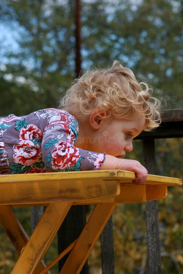 Cute Girl on Yellow Table stock photo. Image of cute, beautiful - 9171612