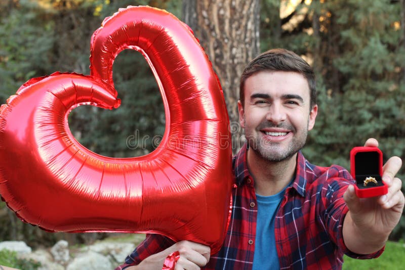 Cute Guy Proposing with Heart Balloon Stock Photo - Image of engagement ...