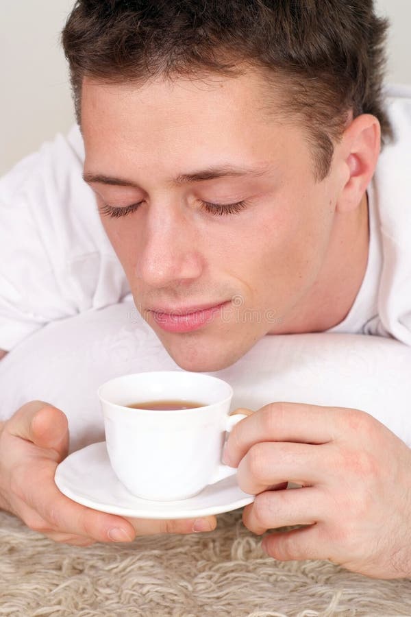 Cute guy with tea stock photo. Image of thinking, carpet - 23869402