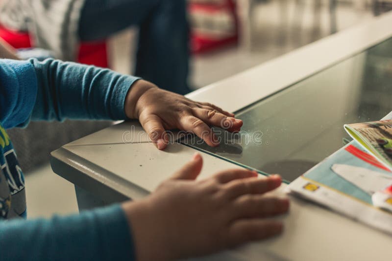 Cute Hands of a Child on the Corner of the White Table Stock Image ...