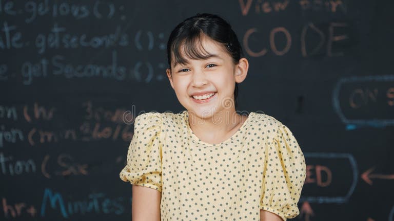 Cute Happy Girl Smiling To Camera while Standing at Blackboard ...