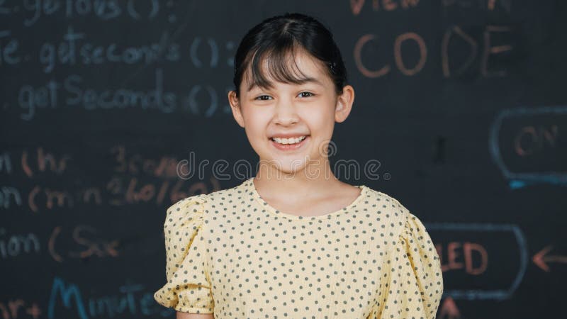 Cute Happy Girl Smiling To Camera while Standing at Blackboard ...