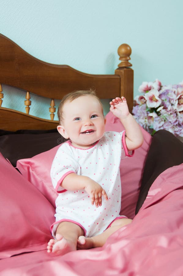 Cute Happy Laughing Baby Playing on Bed. Stock Photo - Image of robe ...