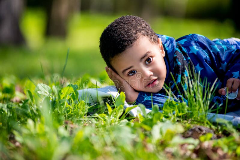 Cute Happy Little Boy Lying in Green Grass on Spring Stock Image ...