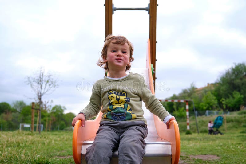 Cute Happy Little Boy Playing on Slide in Playground Stock Image ...