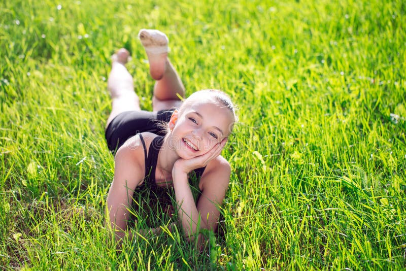 Cute Happy Little Girl Lying on the Grass. Stock Photo - Image of ...