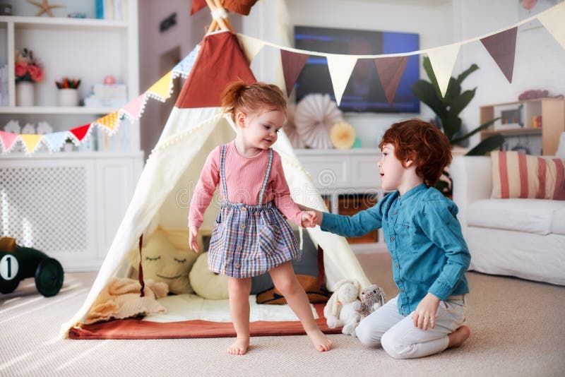 Cute Happy Siblings Playing Together in Nursery Room at Home Stock ...