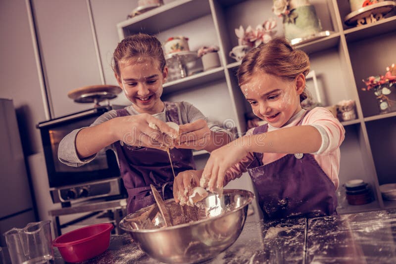 Cute Happy Sisters Adding Eggs To the Dough Stock Photo - Image of ...