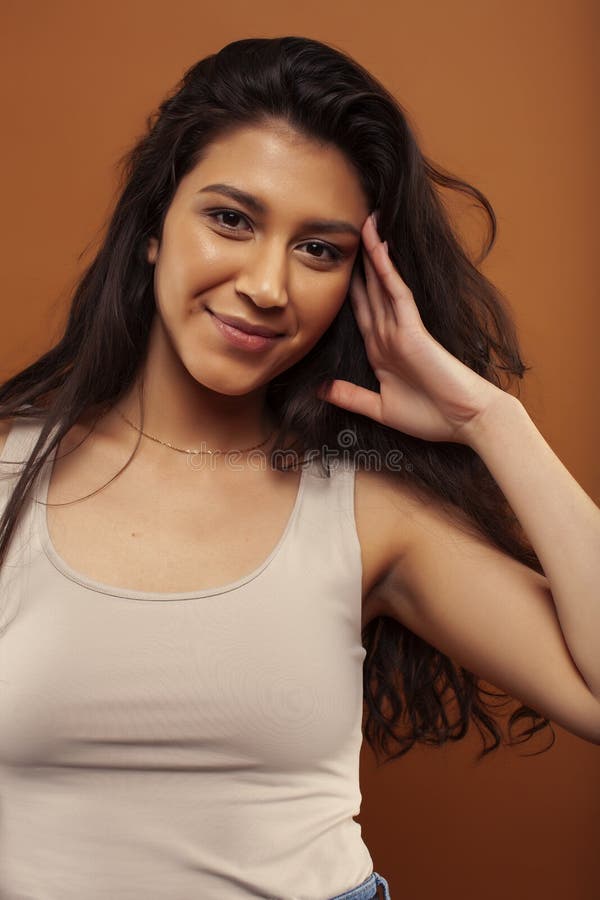 Cute Happy Young Indian Woman Posing Cheerful On Brown Background In