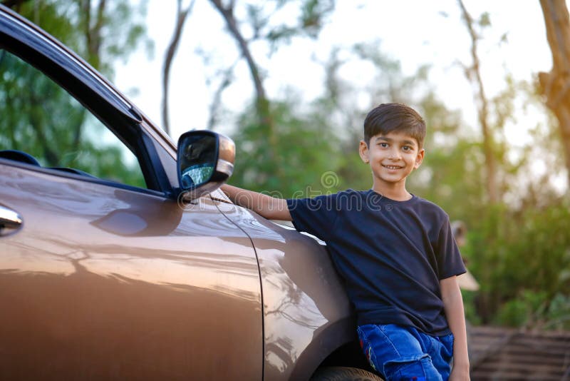 Cute Indian child with car stock image. Image of person - 150501755