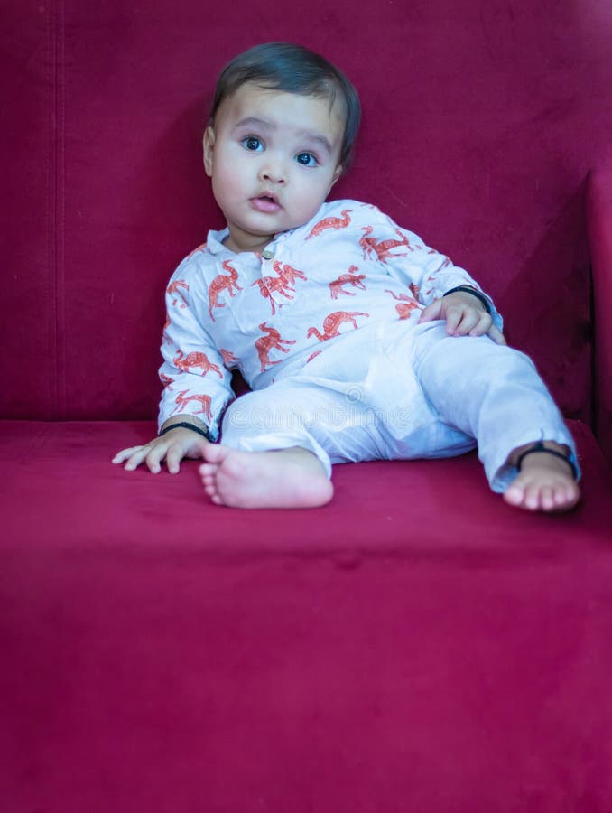 Cute Infant Isolated Sitting at Red Sofa from Different Angle Stock ...