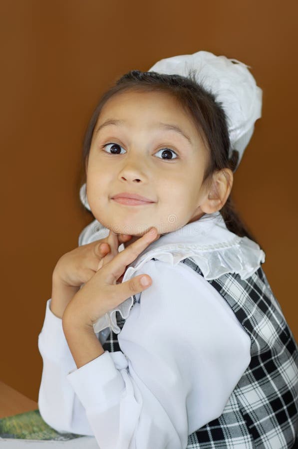 A Cute Joyful Girl with a White Bow, a Student of the First Grade of ...