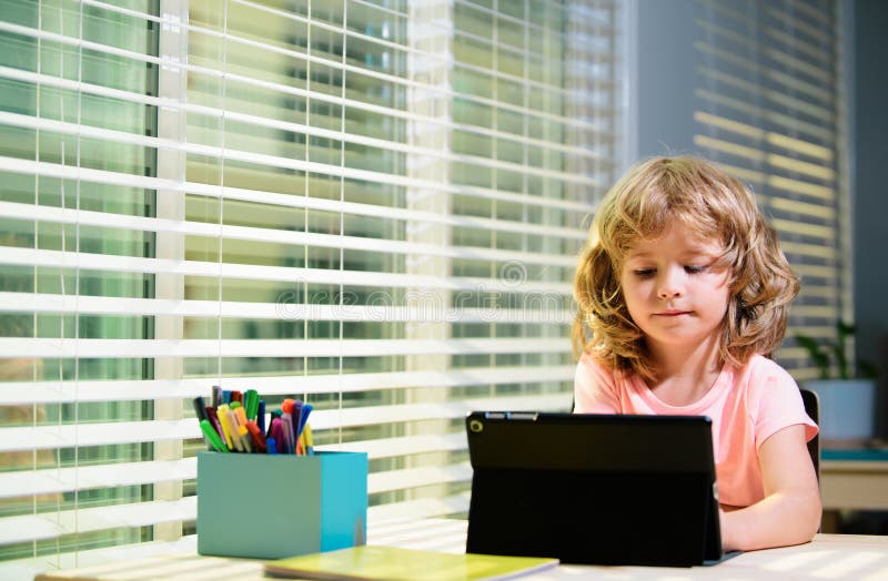 Cute Kid Boy Using Tablet on Desk at Home. Online Education Concept ...