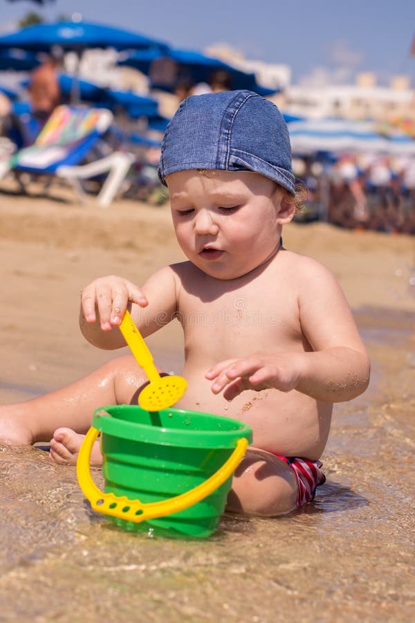 Cute Kid Playing on the Beach with Sand and Water. Stock Image - Image ...